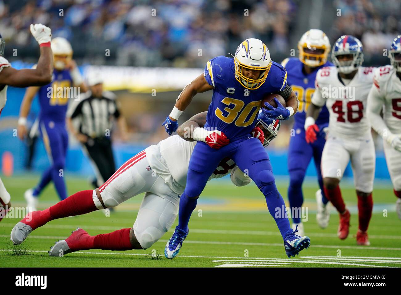 Los Angeles Chargers running back Austin Ekeler (30) is tackled by New ...