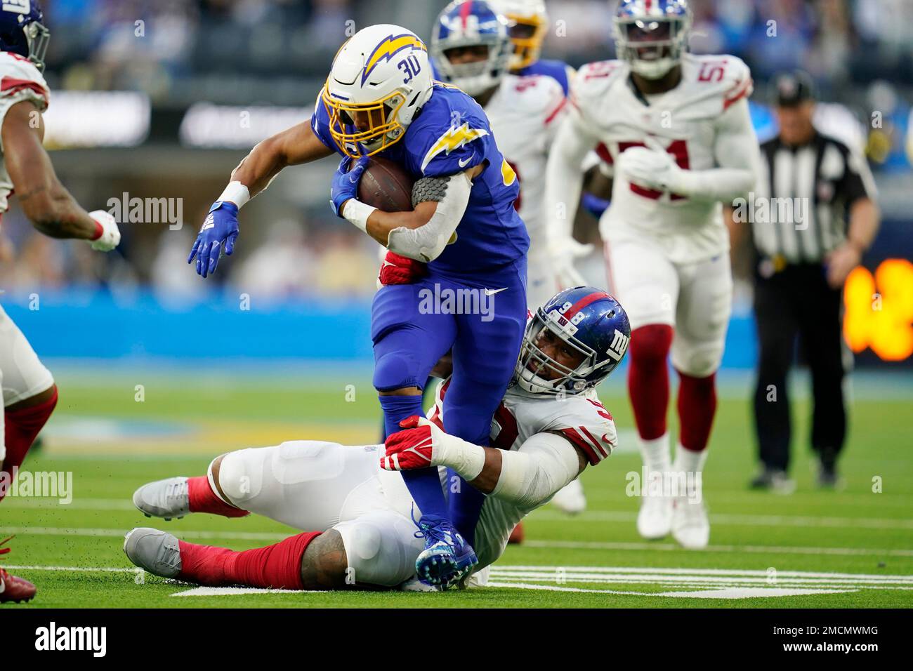 Los Angeles Chargers running back Austin Ekeler (30) is tackled by New ...