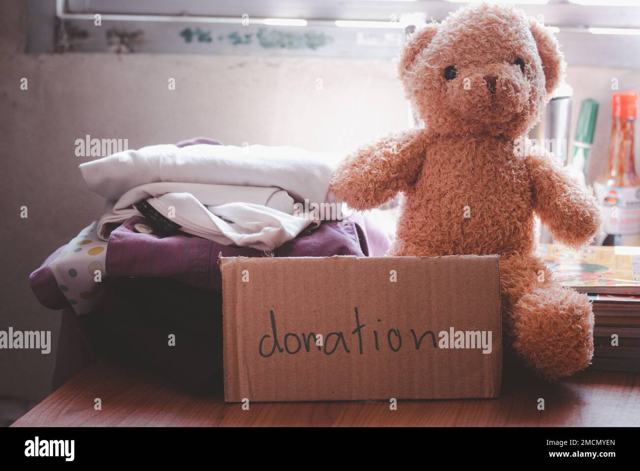 Clothes, books, teddy bears for donations. Social donation concept Stock Photo - Alamy