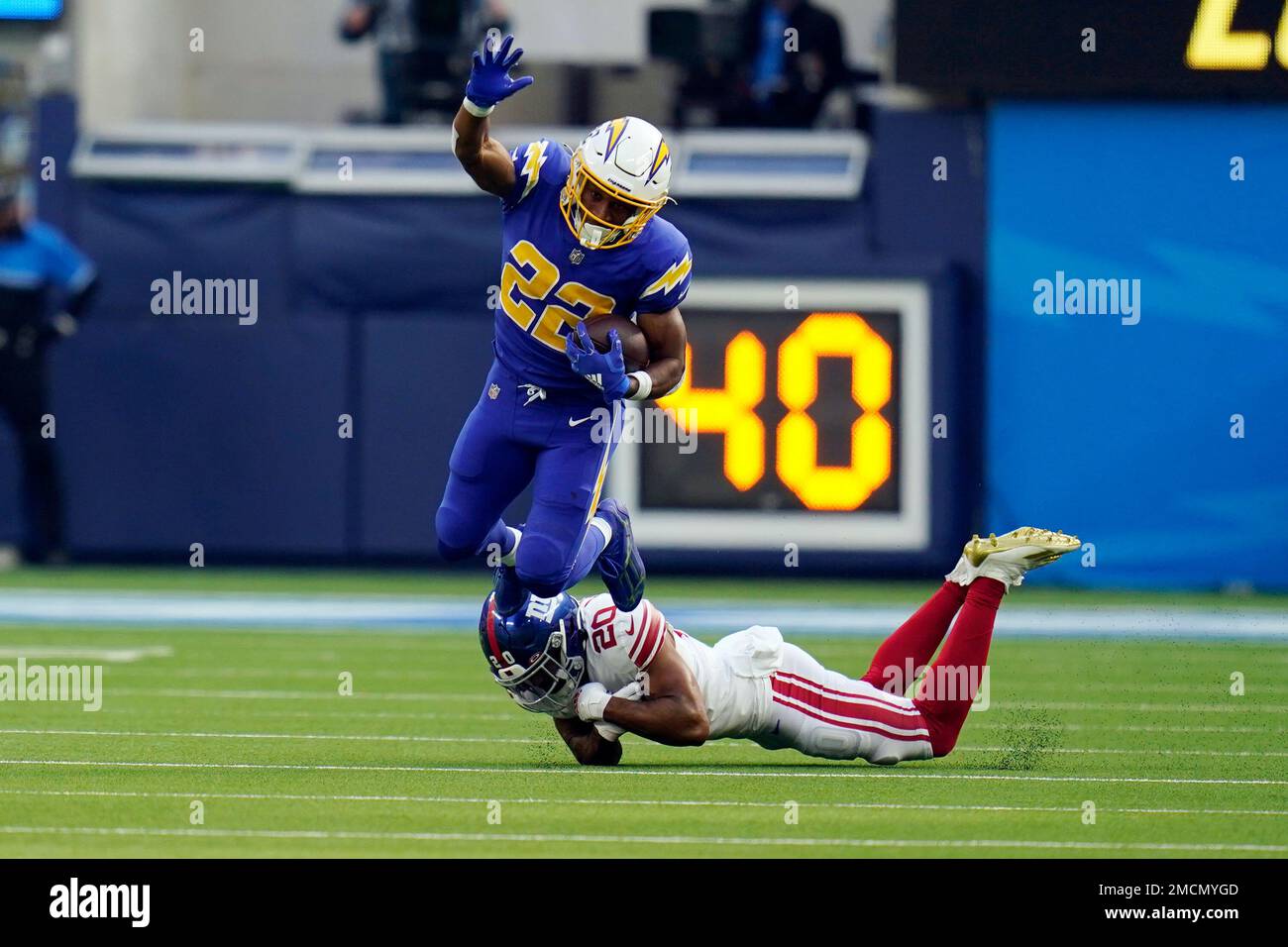 Los Angeles Chargers running back Justin Jackson (22) is tackled by New ...