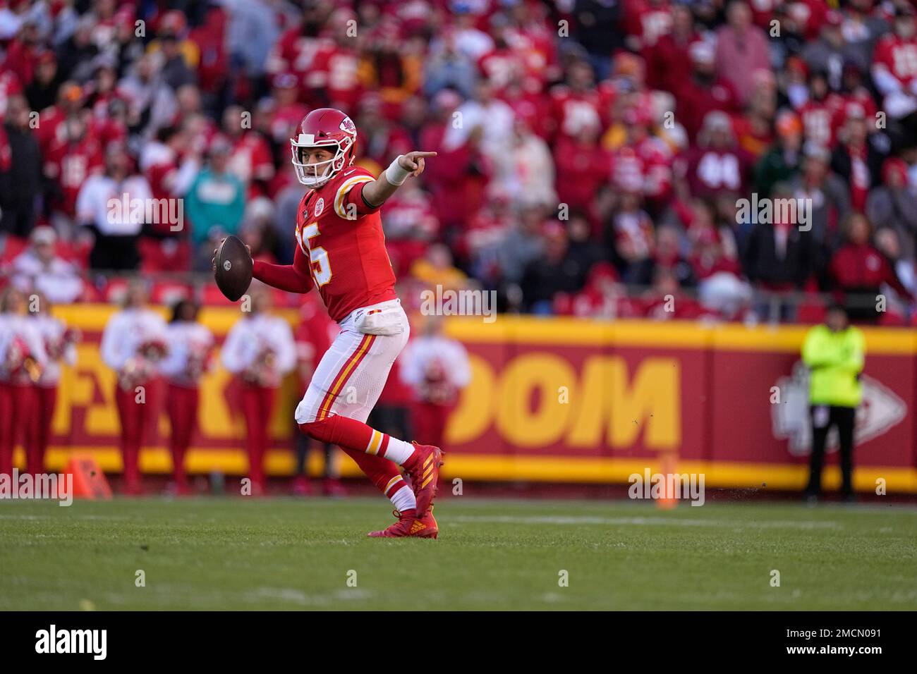 Kansas City Chiefs quarterback Patrick Mahomes points as he scrambles ...