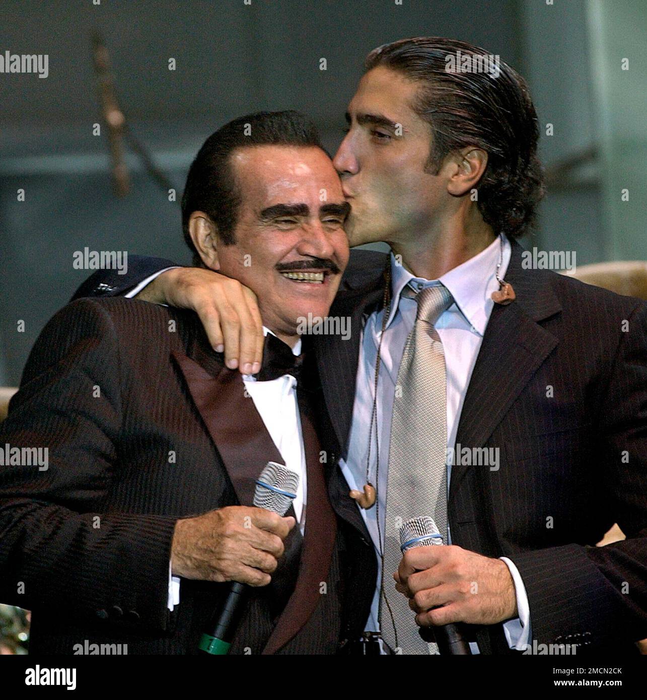 FILE - Mexico's "King of Ranchero" Vicente Fernandez, left, is embraced ...