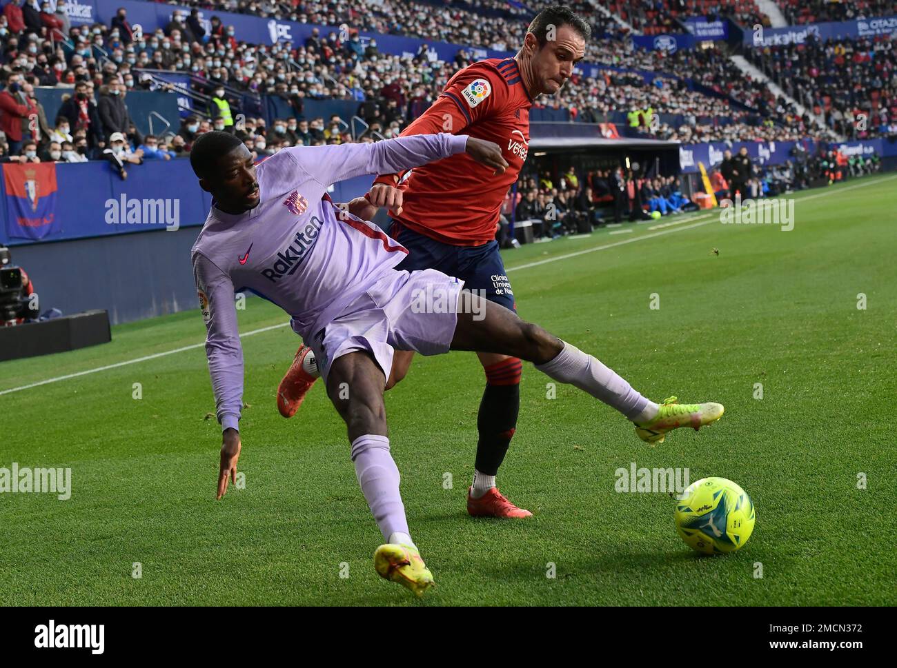 Osasuna's Kike Garcia, right challenges Barcelona's Ousmane Dembele ...