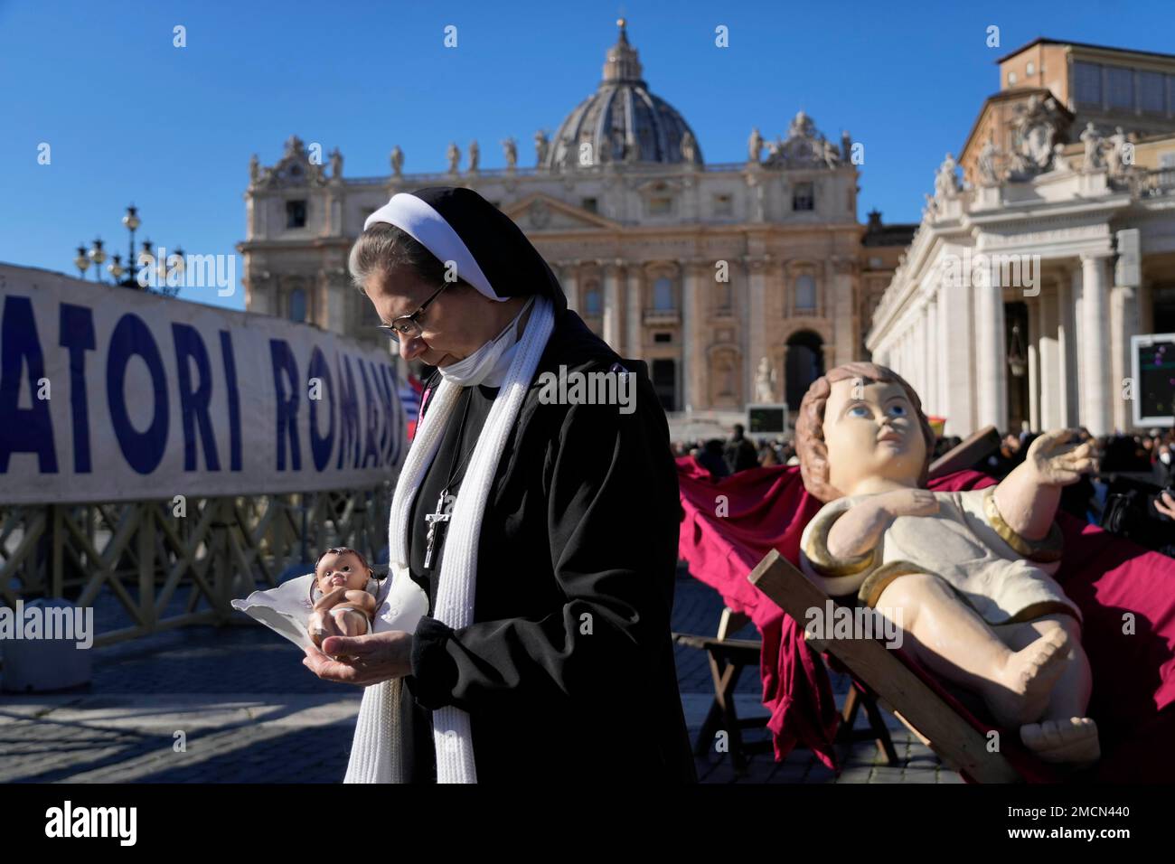 A ruin holds a statue of baby Jesus during Pope Francis' Angelus noon ...