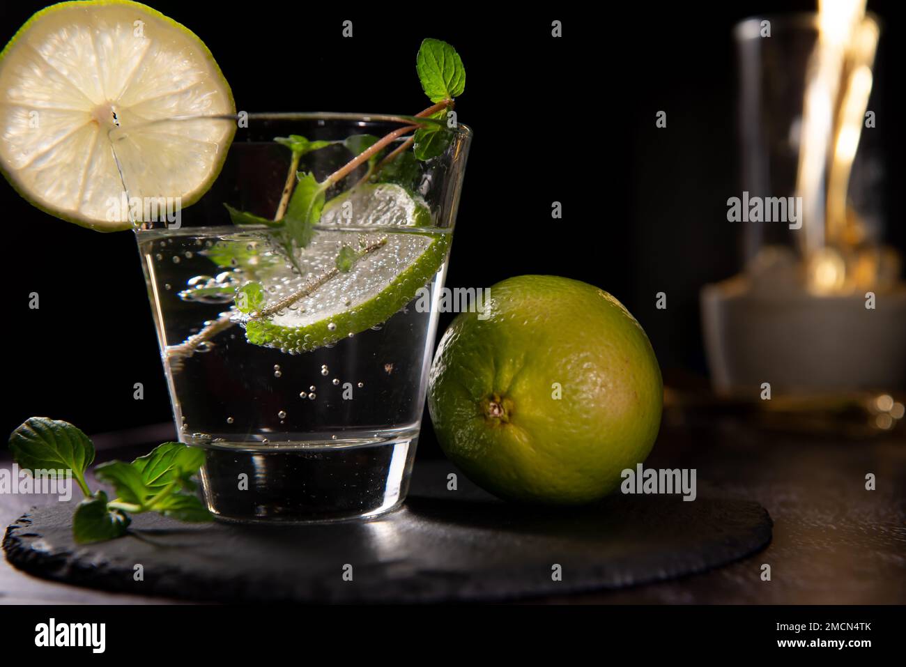 A closeup of a glass of Mojito with lime in a bar Stock Photo - Alamy