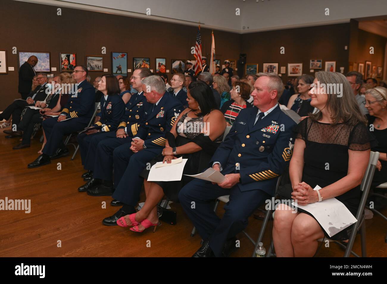 Guests listen to various speakers at the Coast Guard Art Program ...