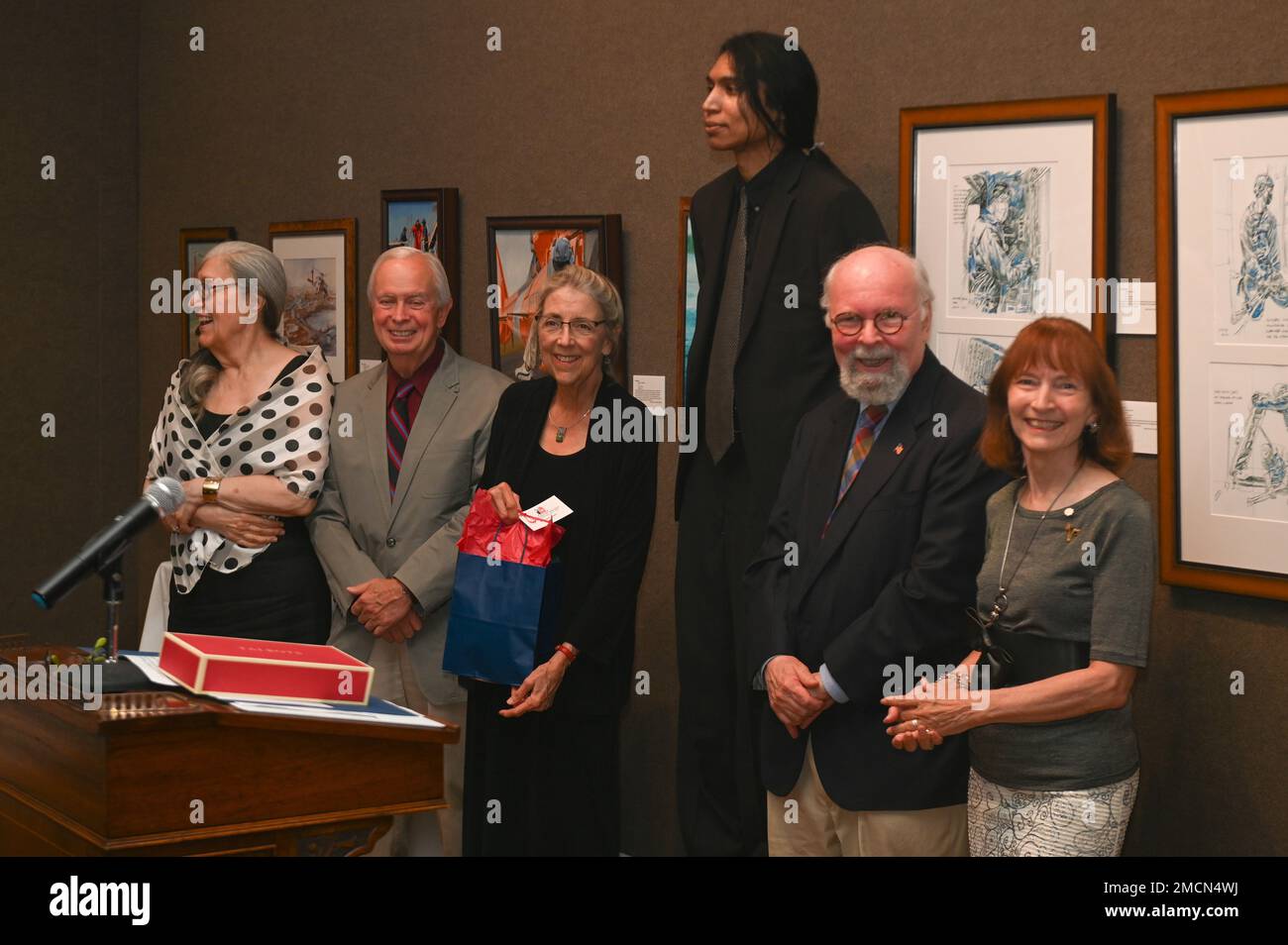 U.S. Coast Guard Art Program Coordinator Mary Ann Bader accepts a gift ...
