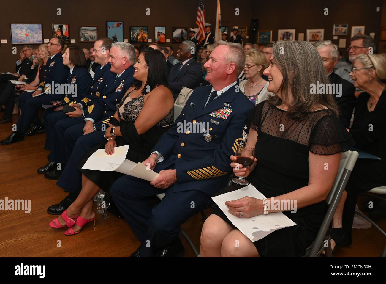 Guests listen to various speakers at the Coast Guard Art Program ...