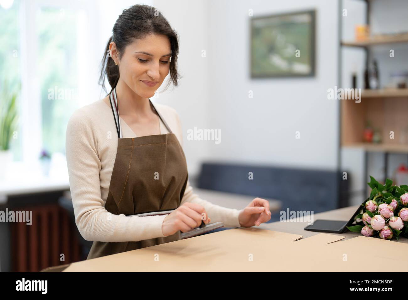 Florist working with flowers making a composition Stock Photo - Alamy