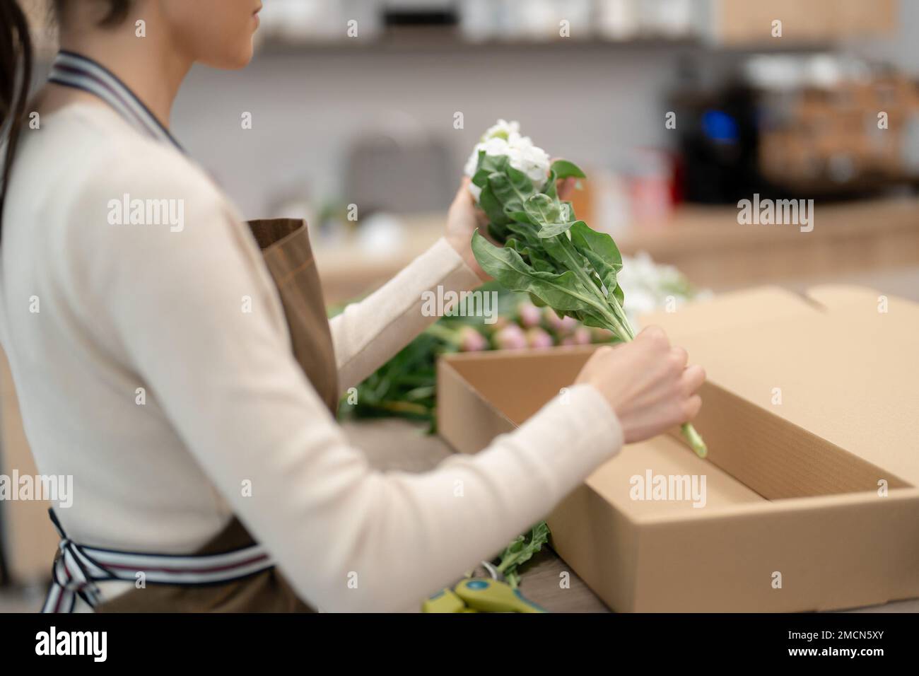 Florist working with flowers making a composition Stock Photo - Alamy