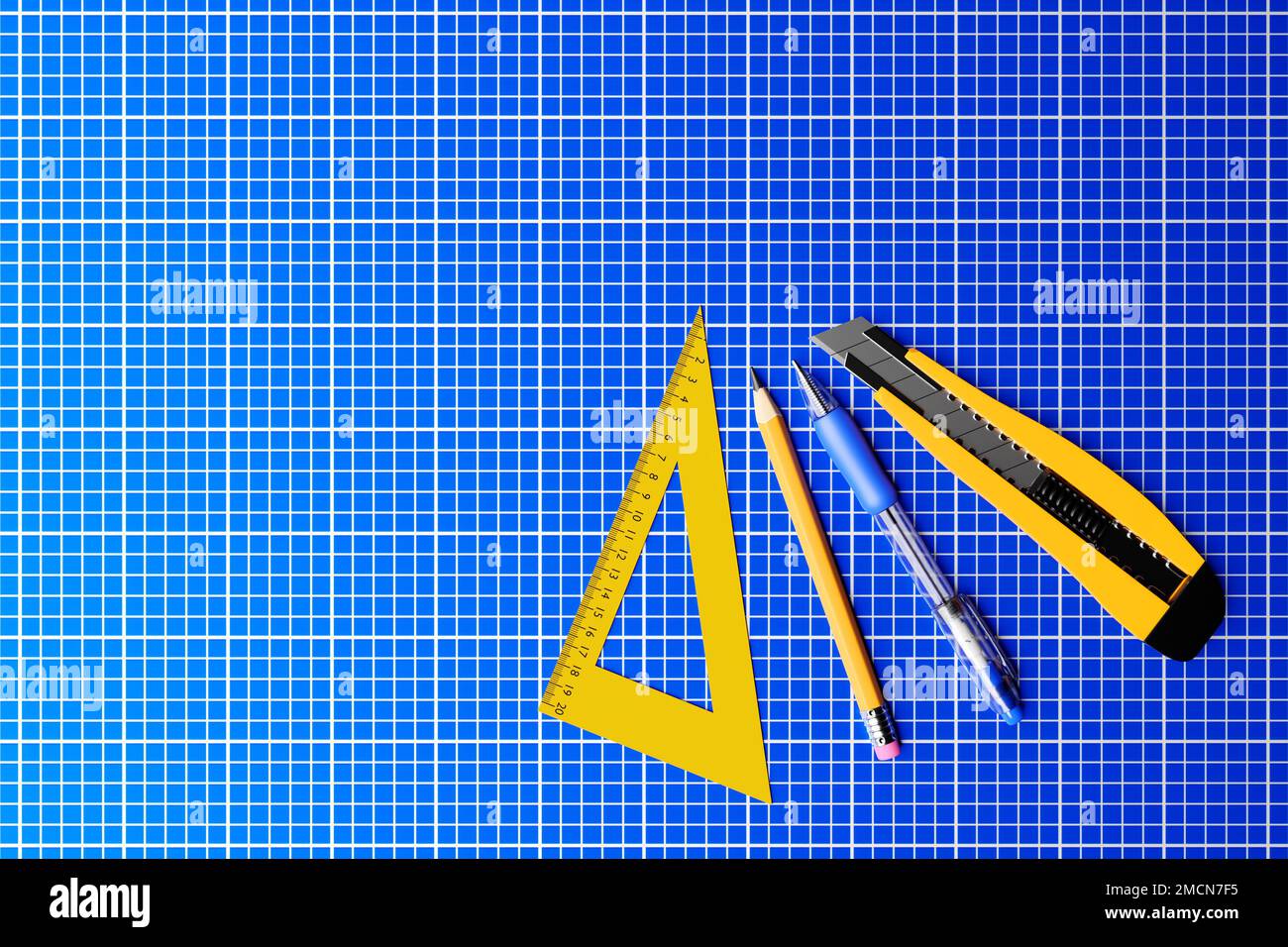 3D illustration yellow cutter, pencil, pen and ruller on blue ...