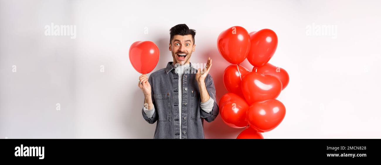 Valentines day concept. Cheerful young man celebrating love holiday ...