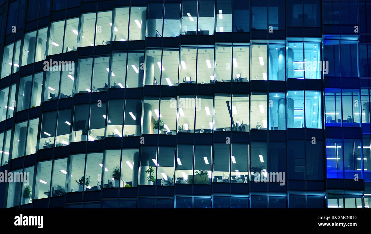 Pattern of office buildings windows illuminated at night. Glass ...