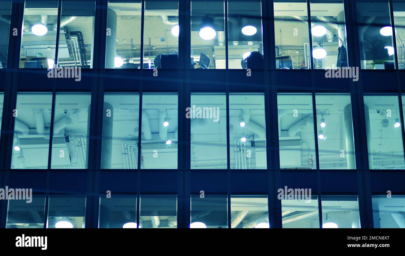 Pattern of office buildings windows illuminated at night. Glass ...