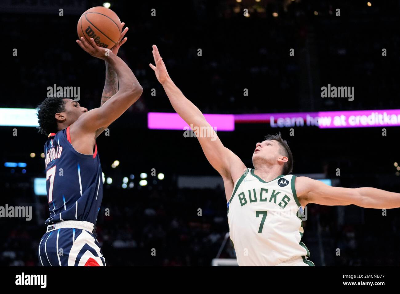 Houston Rockets guard Armoni Brooks, left, shoots as Milwaukee Bucks ...