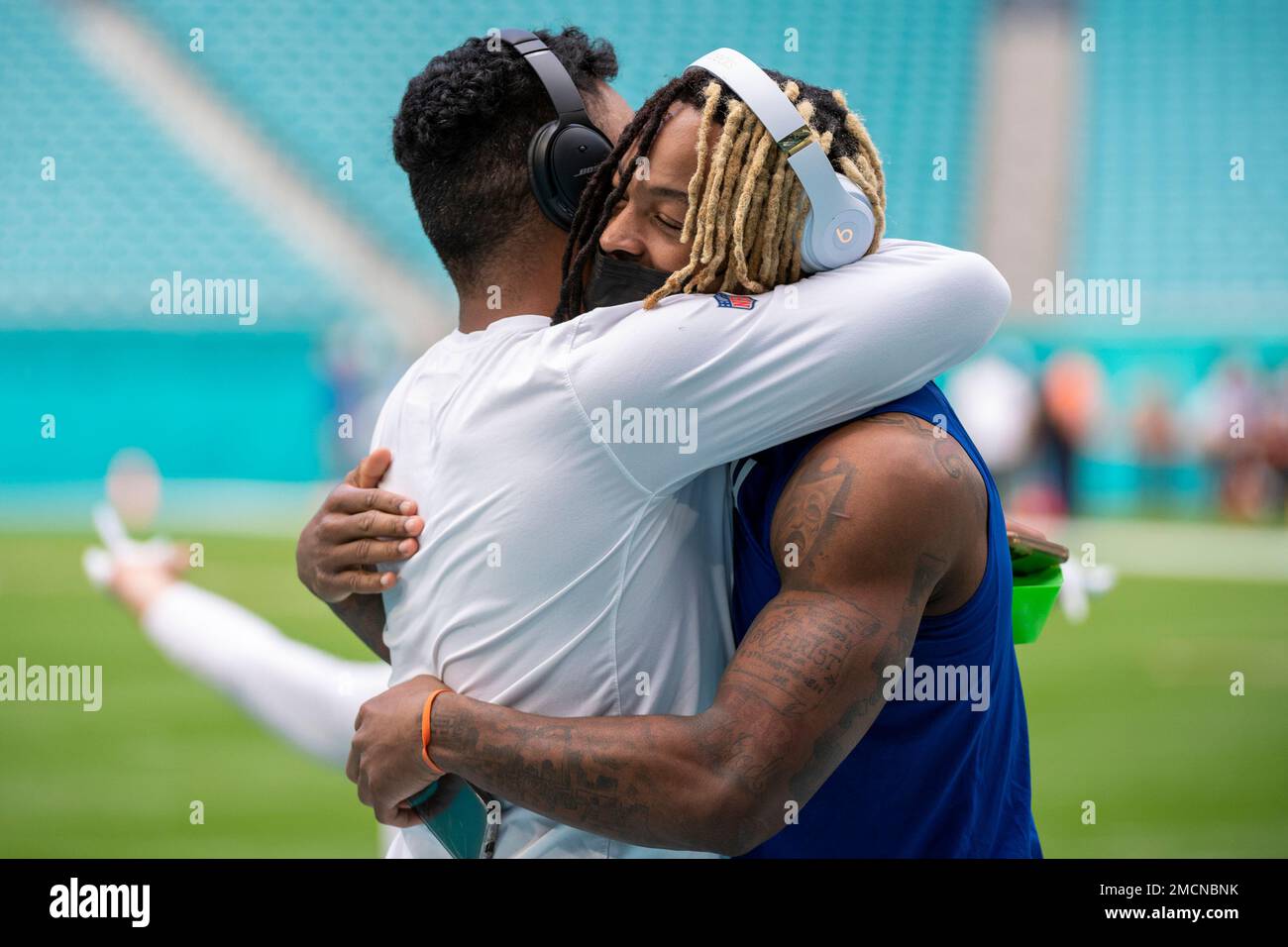 New York Giants safety Xavier McKinney (right) hugs Miami Dolphins ...