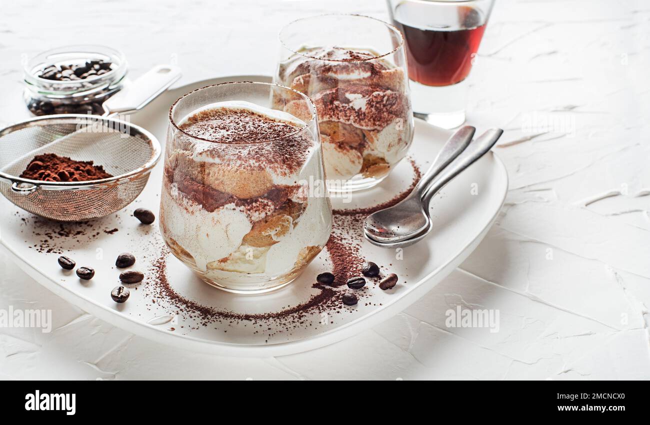 Traditional Italian dessert tiramisu in a glass cup. Homemade tiramisu ...