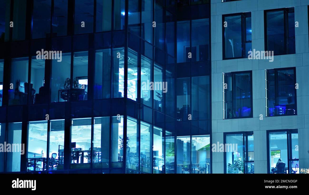 Pattern of office buildings windows illuminated at night. Glass ...