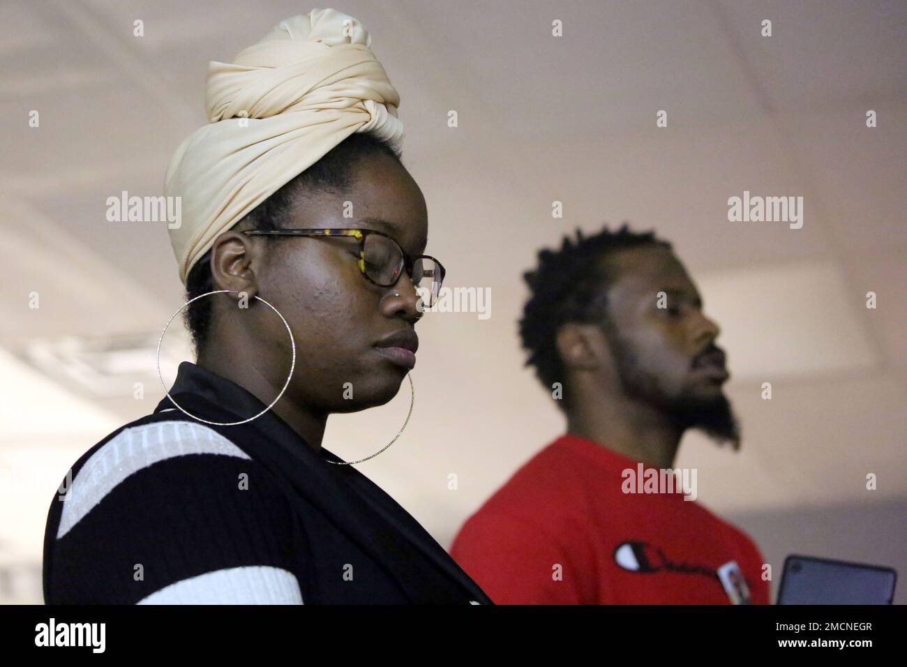 Victoria Williams and Menelik Tafari pray during an event by the ...