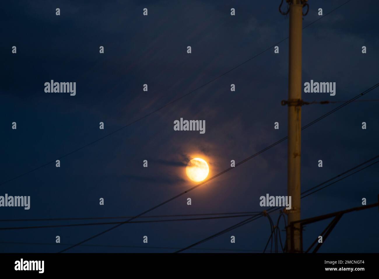 power line against the background of the moon in the sky at sunset at ...