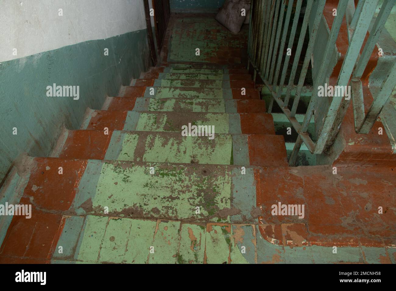 old dirty staircase without repair with a staircase in a residential ...