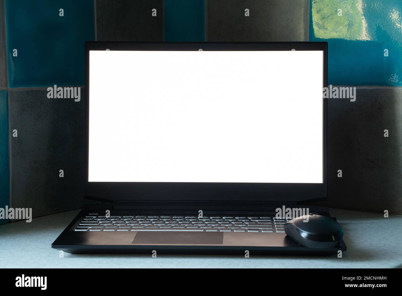 black laptop with white screen stands on the kitchen on the table at ...