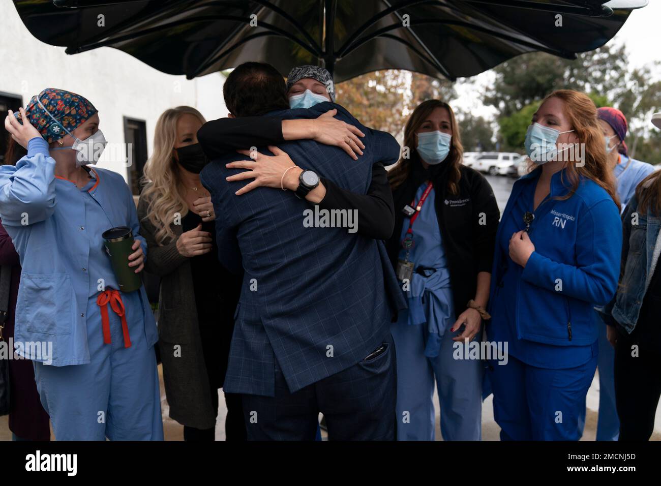 Registered nurse Lisa Lampkin, center, facing camera, hugs her former ...