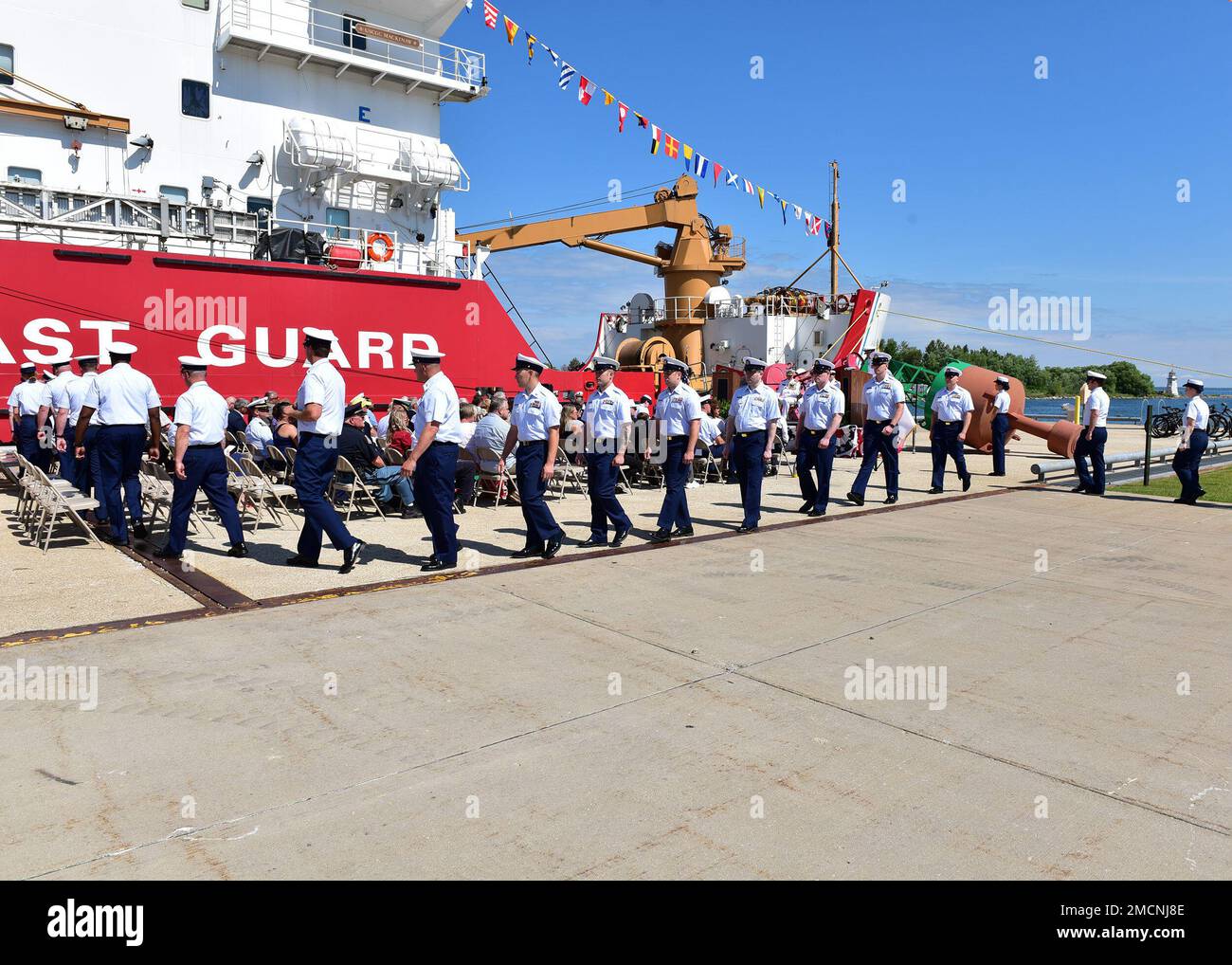 Crew of Coast Guard Cutter Mackinaw take their seats during a change of ...