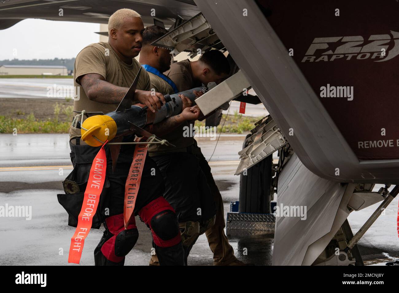 U.S. Airmen assigned to the 525th Aircraft Maintenance Unit load a ...