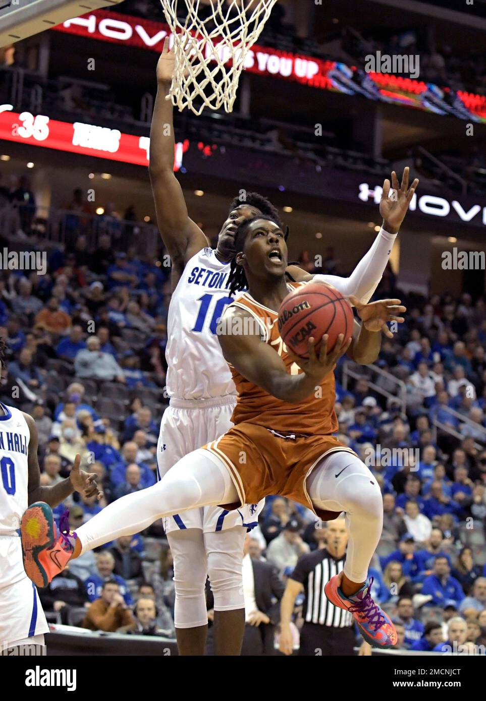 Texas forward Timmy Allen, front, goes up to shoot as he gets by Seton ...