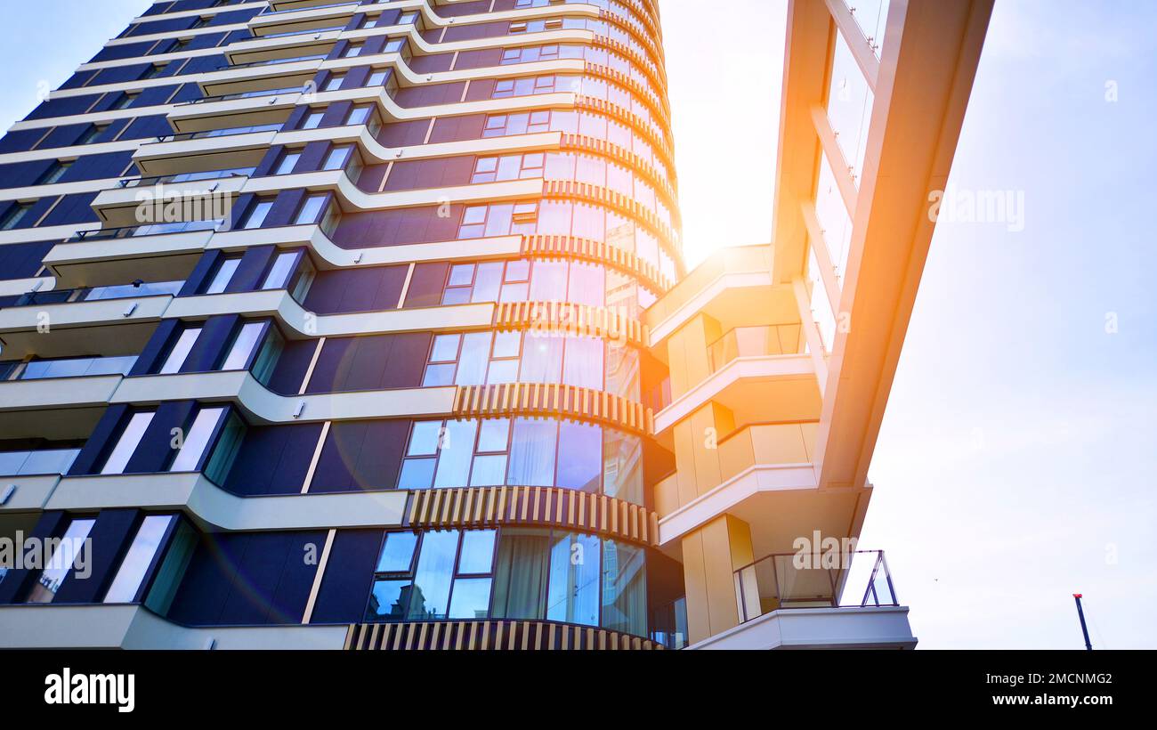 Exterior of a high modern multi-story apartment building - facade, windows and balconies Stock ...