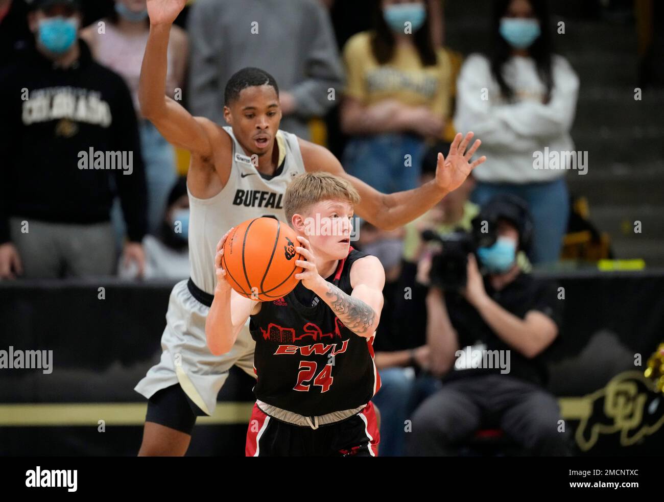 Eastern Washington guard Mason Landdeck, front, looks to pass the ball ...