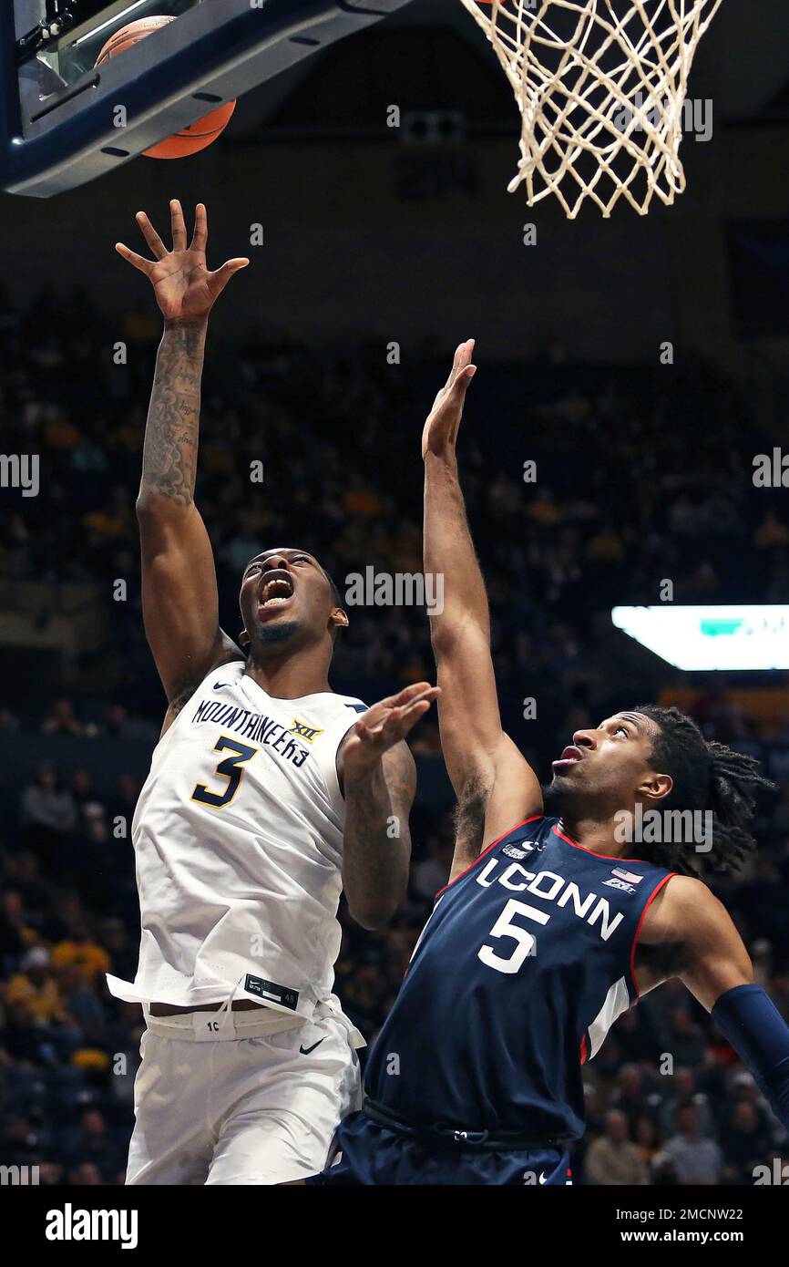 West Virginia forward Gabe Osabuohien (3) shoots as Connecticut forward ...