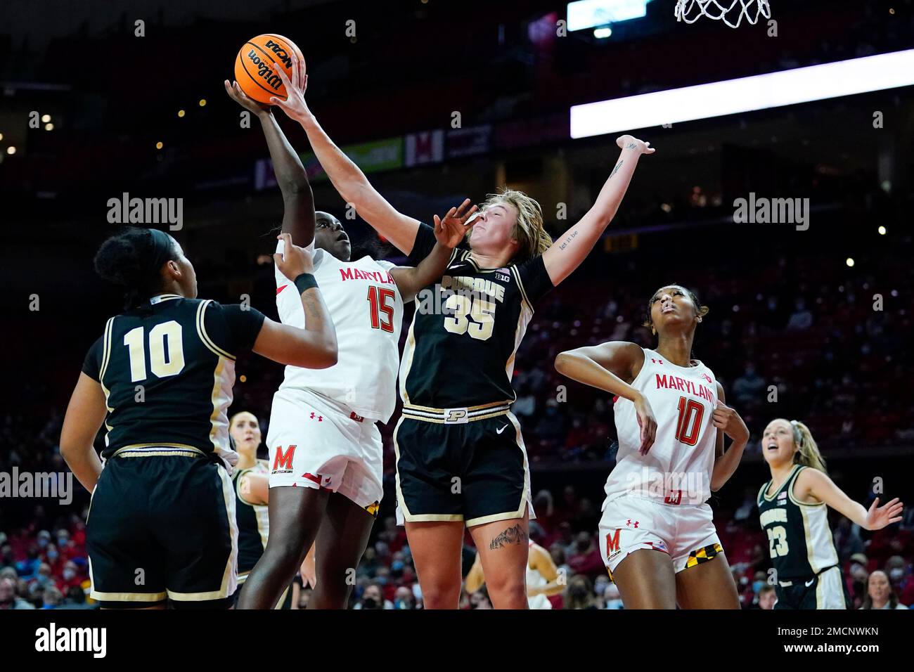 Purdue forward Rickie Woltman (35) blocks a shot by Maryland guard ...