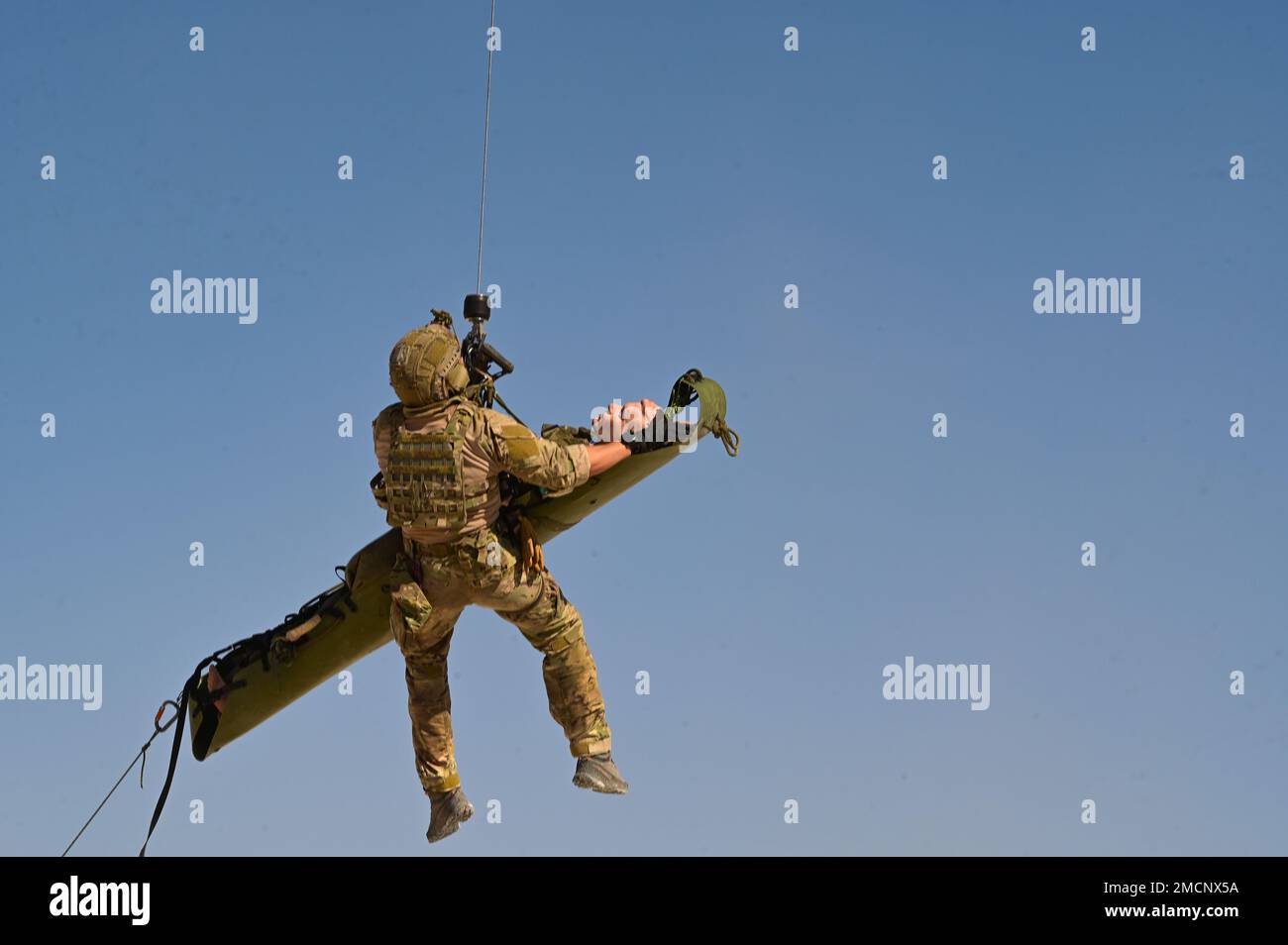 U.S. Air Force pararescueman, assigned to the 52nd Expeditionary Rescue Squadron, is hoisted ...