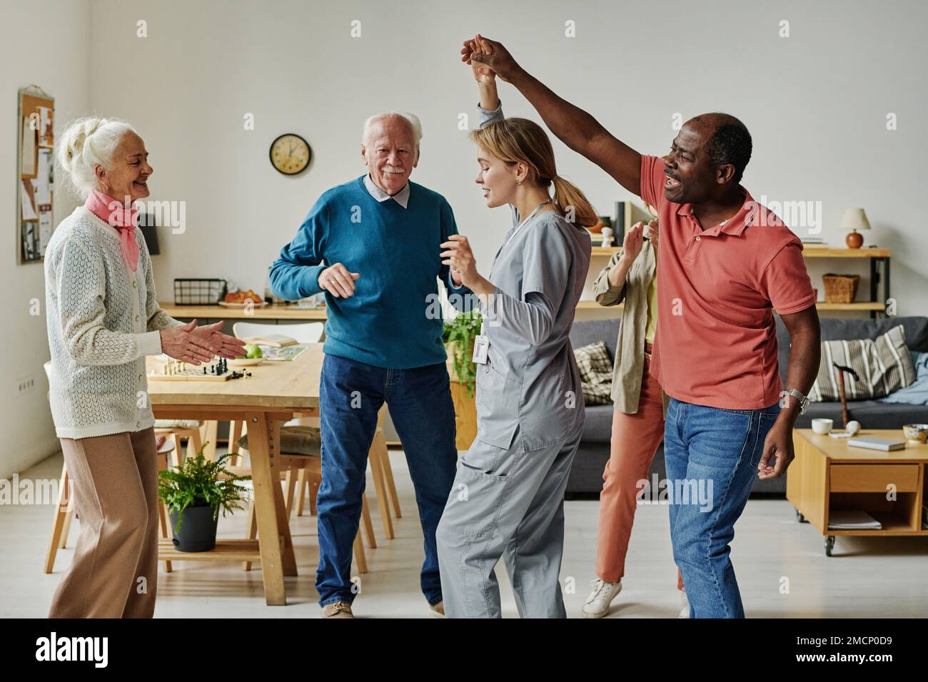 Senior people dancing with their caregiver during dance lesson in ...