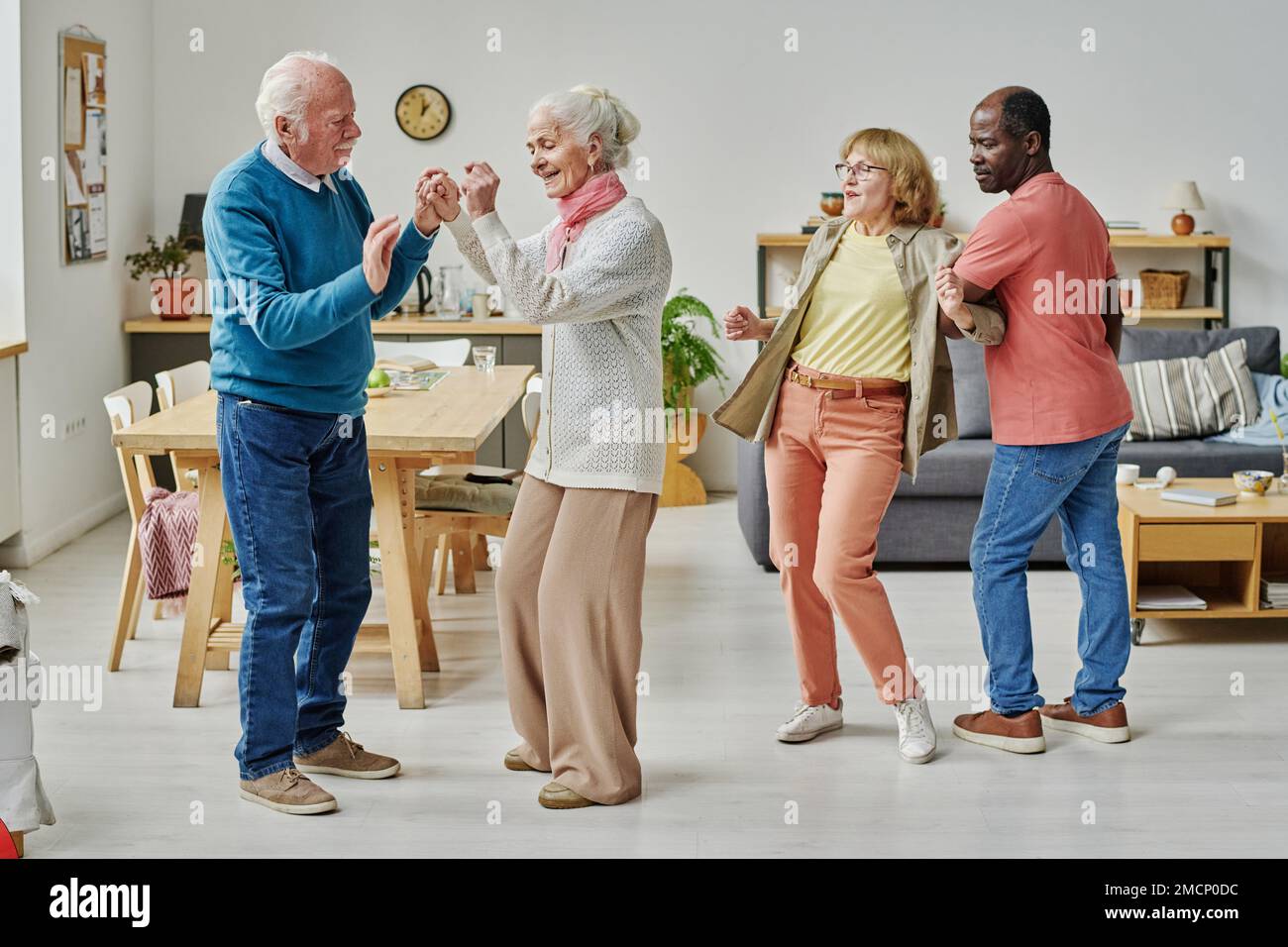 Group of senior people dancing together during party in nursing home ...