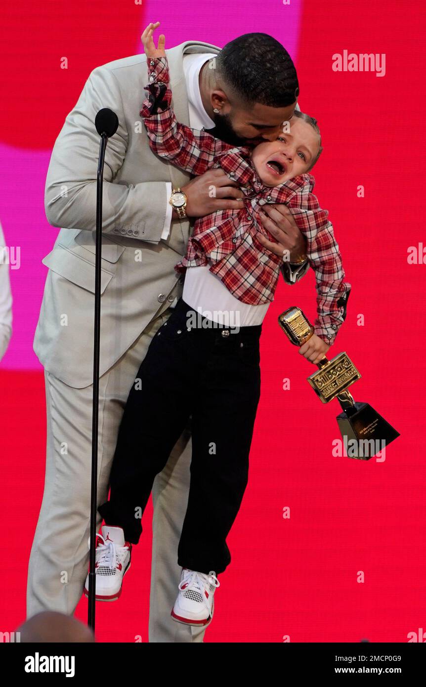 Drake carries his son Adonis Graham as he accepts the artist of the ...