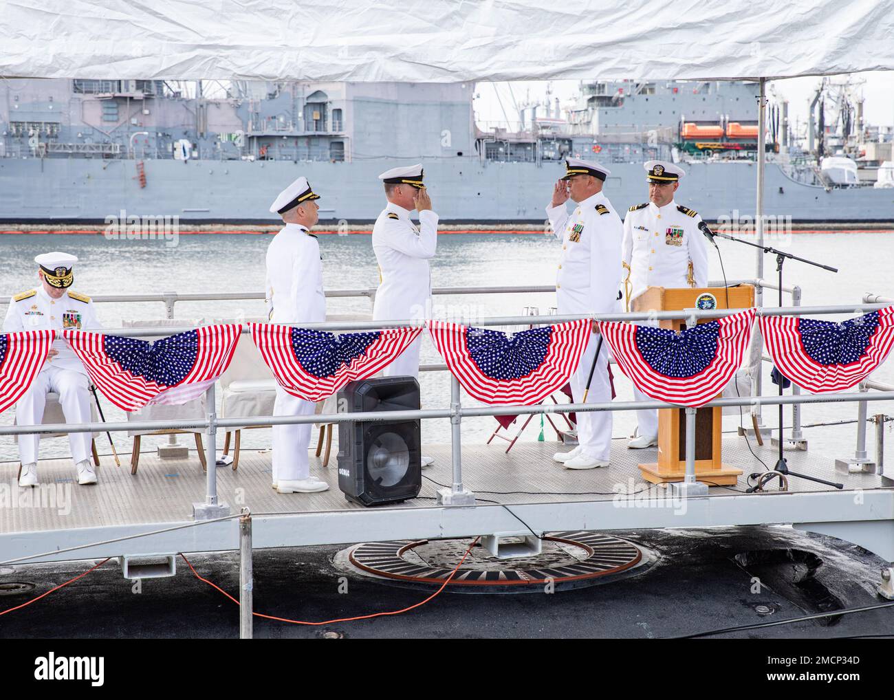 Capt. Jason Pittman, commodore, Submarine Squadron Six, center, renders ...