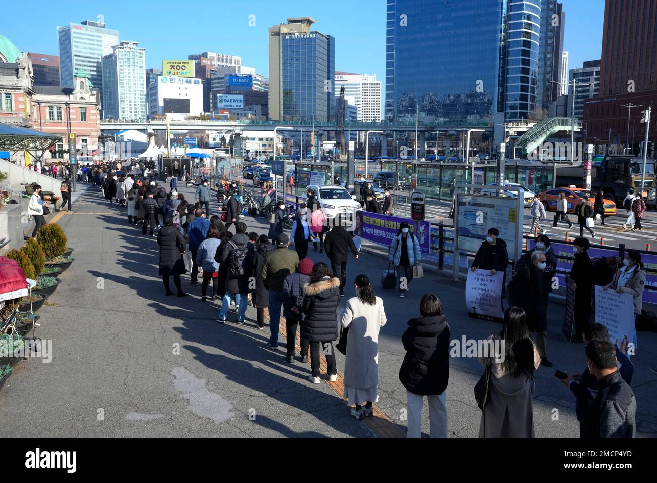 People queue in line to wait for the coronavirus testing at a makeshift ...