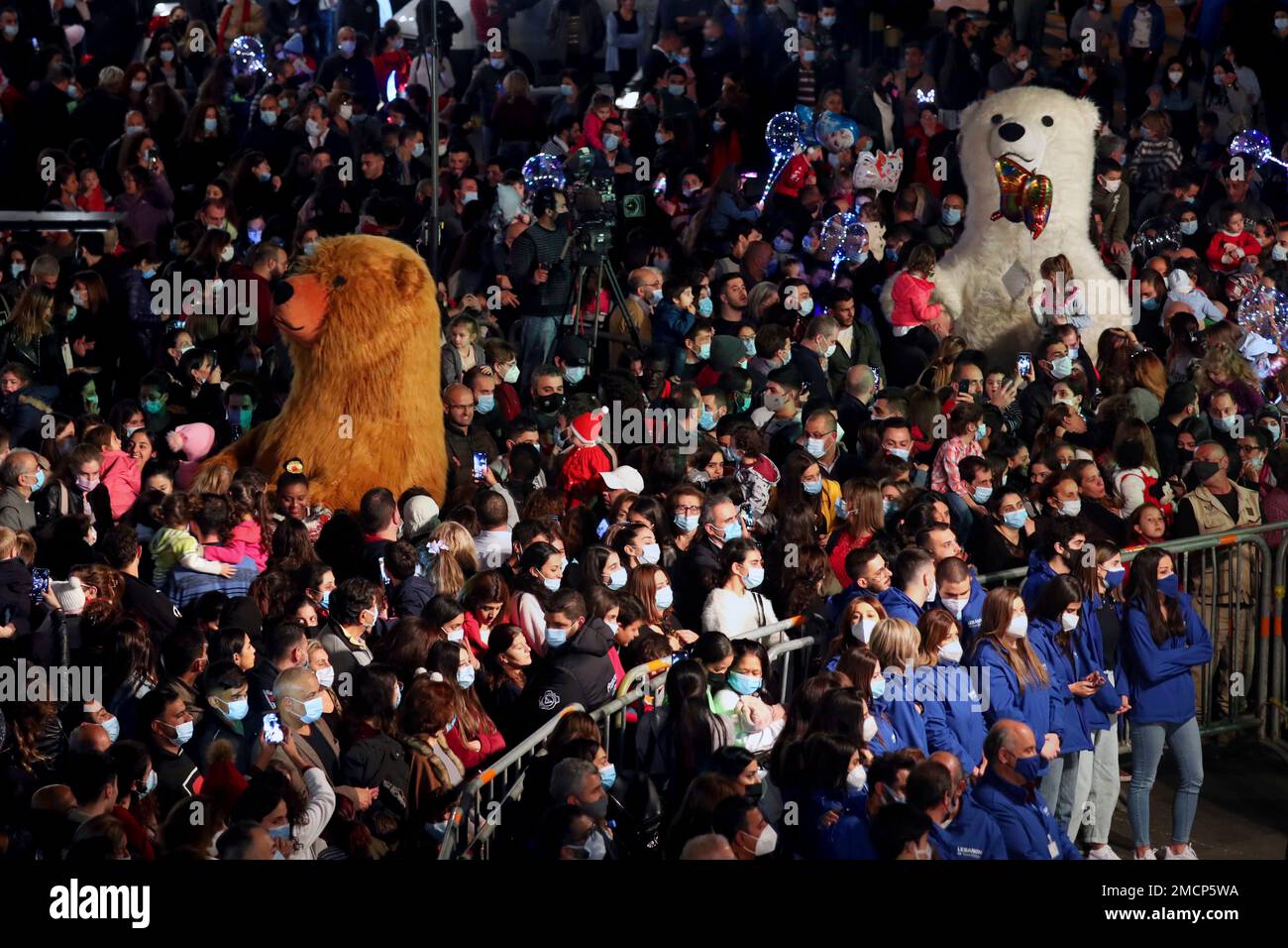 People dressed as teddy bears attend the illumination of a giant ...