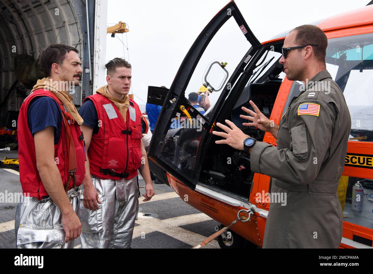 U.S. Coast Guard Lt. Adam Scholl, right, assigned to Coast Guard Air ...