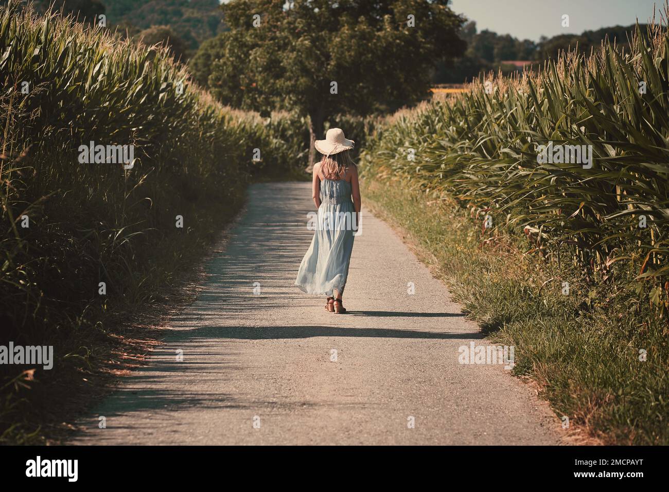 Woman walking among country fields Stock Photo - Alamy