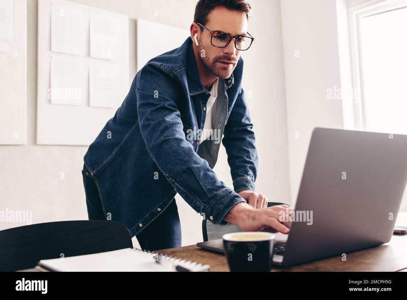 Connecting with the team online. Young businessman joining a virtual ... Connecting with the team online. Young businessman joining a virtual ...