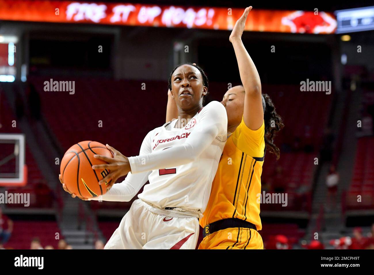 Arkansas guard Samara Spencer (2) drives past California guard Leilani McIntosh (1) during an ...