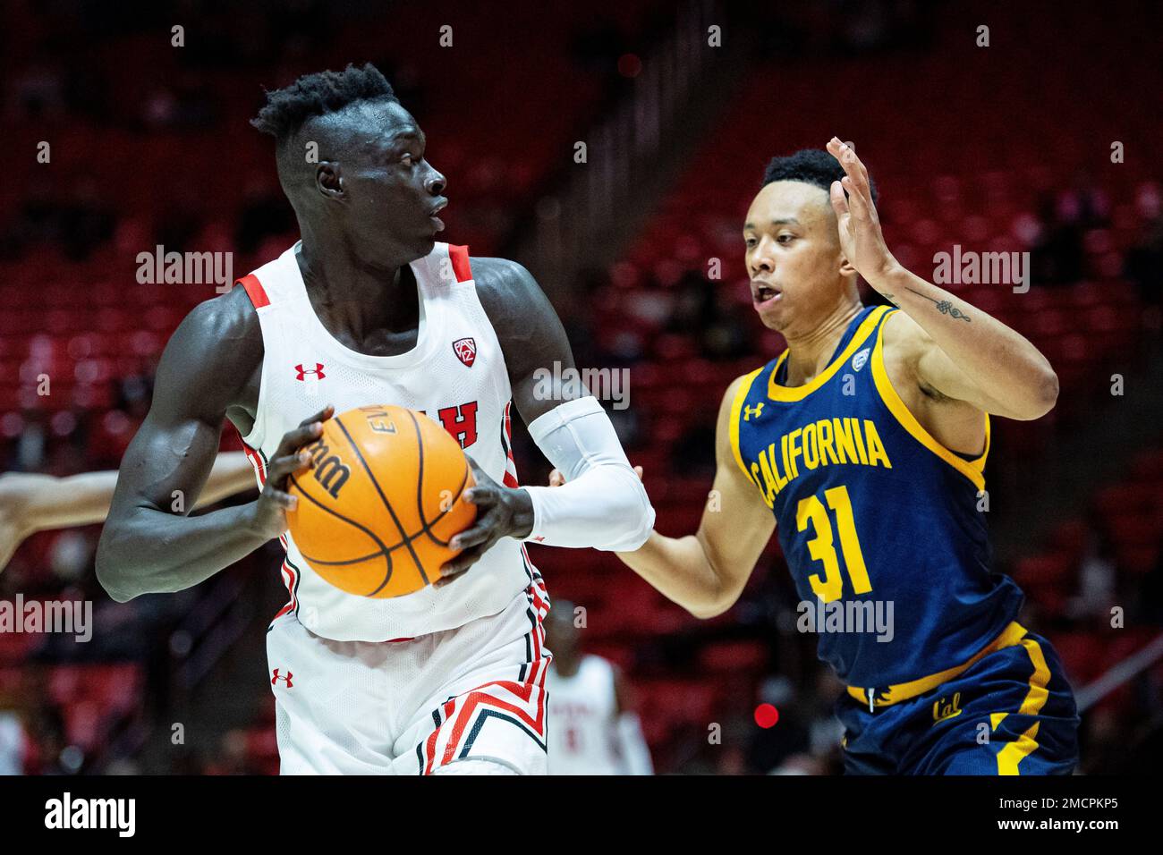 Utah guard Both Gach, left, looks toward the basket while guarded by ...