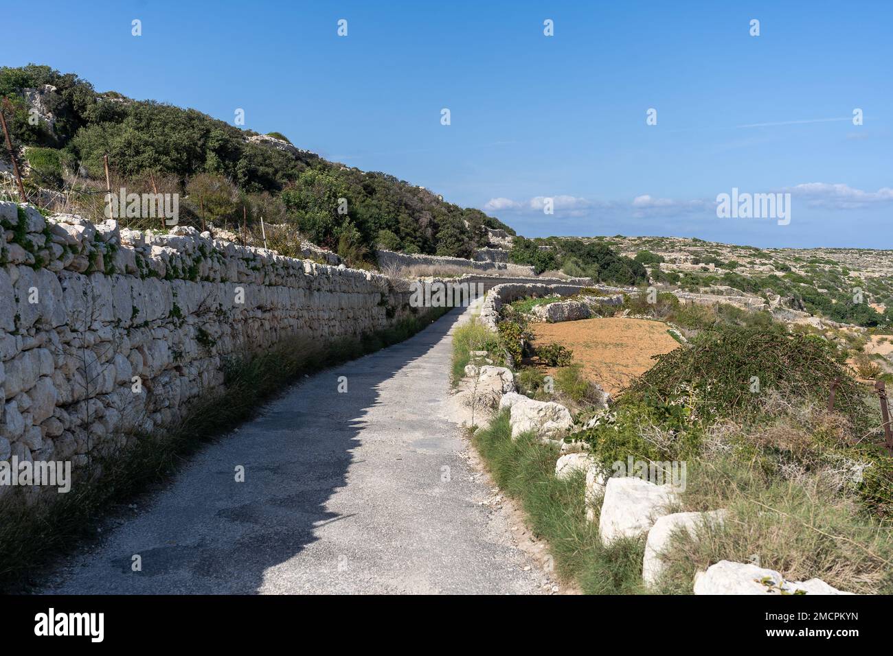 Hiking along beautiful Maltese coastline of Mistra Bay, Mediterranean ...