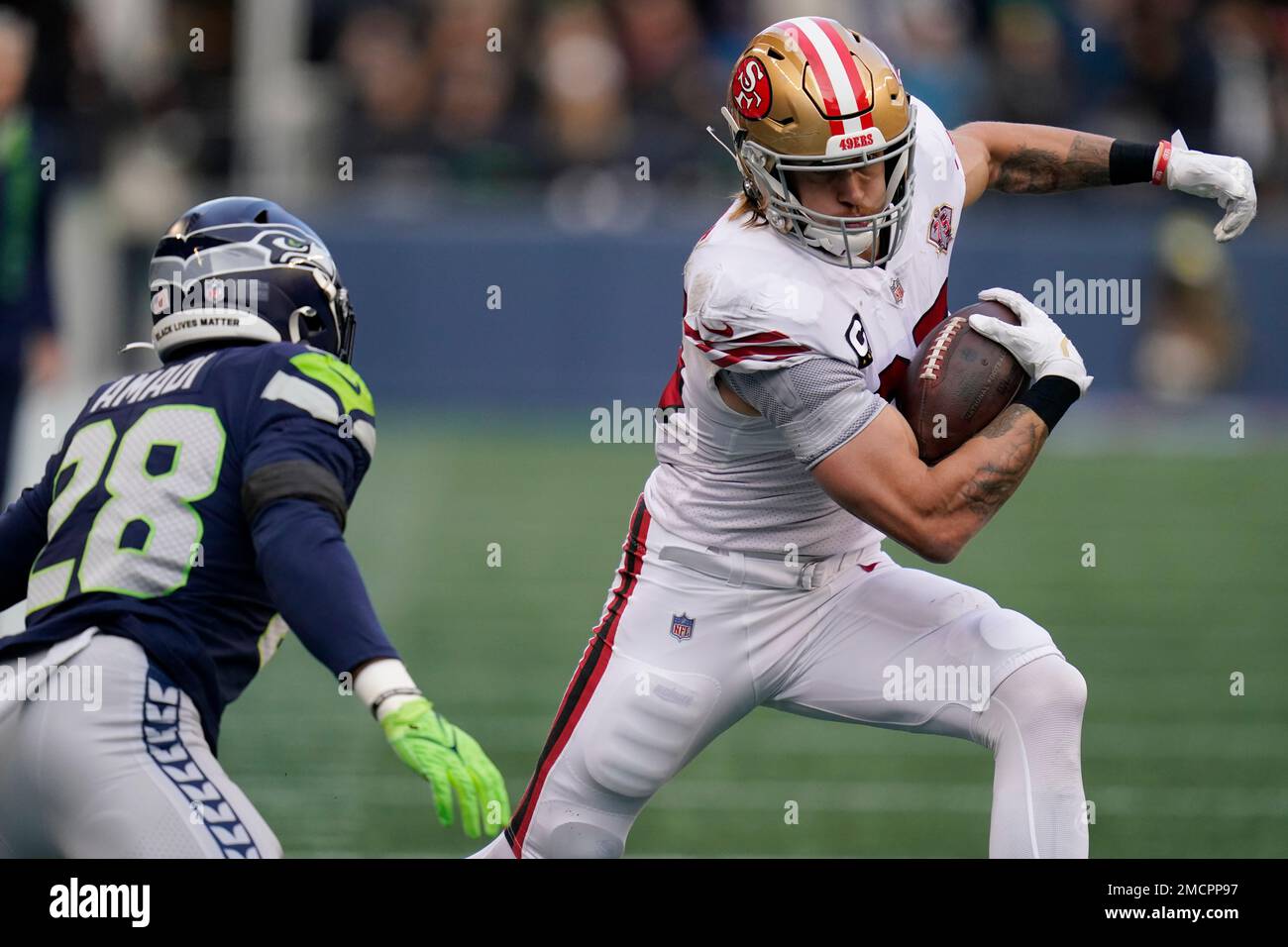 San Francisco 49ers tight end George Kittle, right, tries to avoid ...
