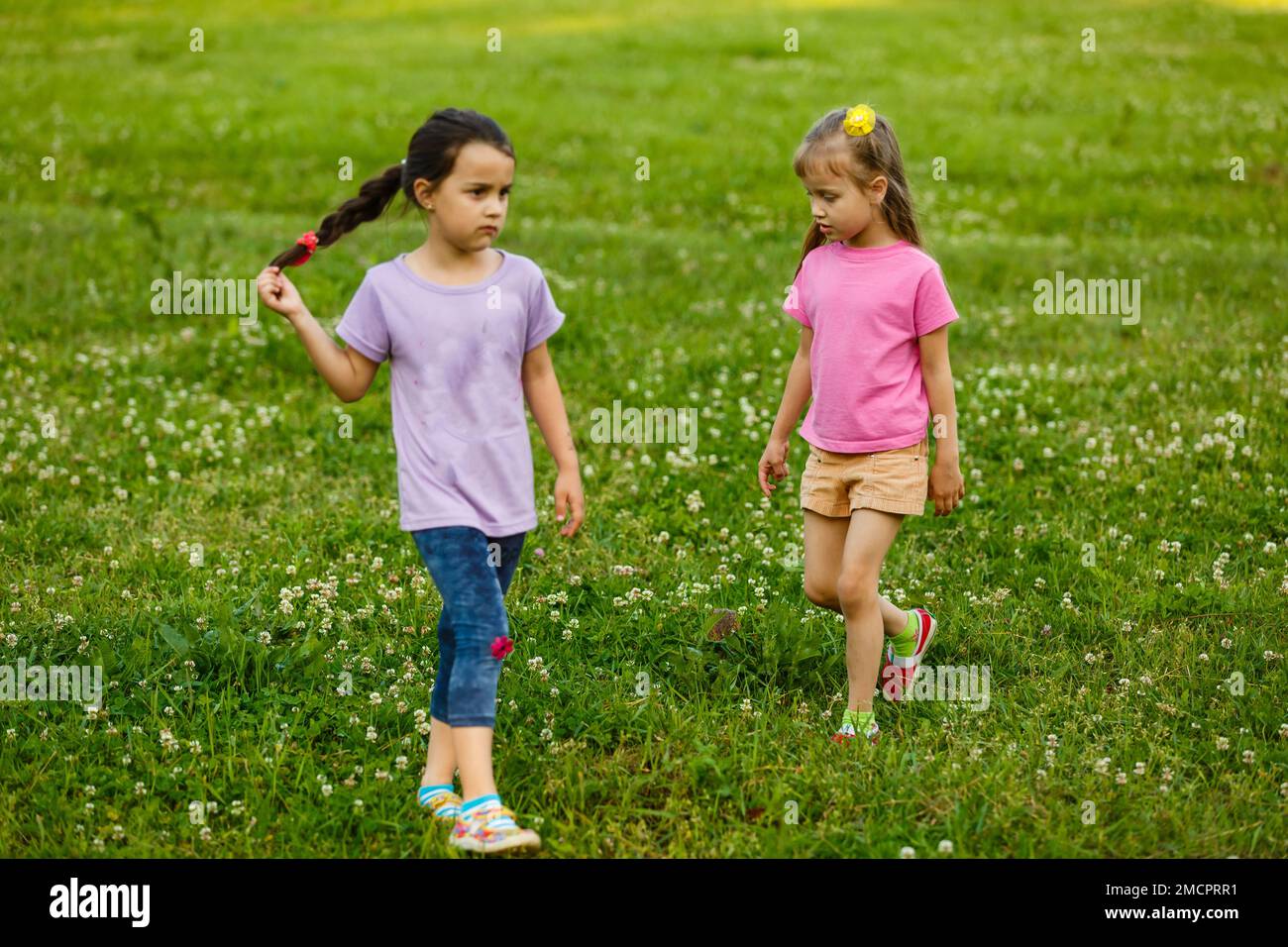 two little friends girls in the field Stock Photo - Alamy