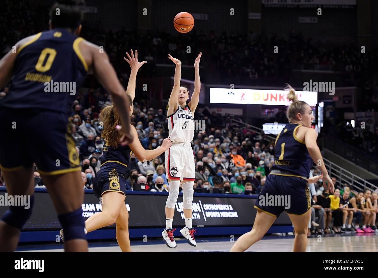 Connecticut's Paige Bueckers shoots over Notre Dame's Madelyn Westbeld ...